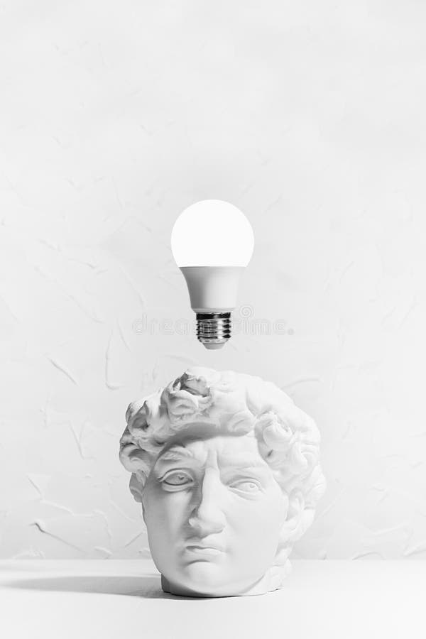 Brainstorming Concept with Glow Light Bulb Over Head of White Antique ...