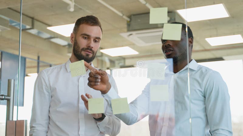 Brainstorming Concept. Two Men Meeting at Office and Use Post it Notes ...