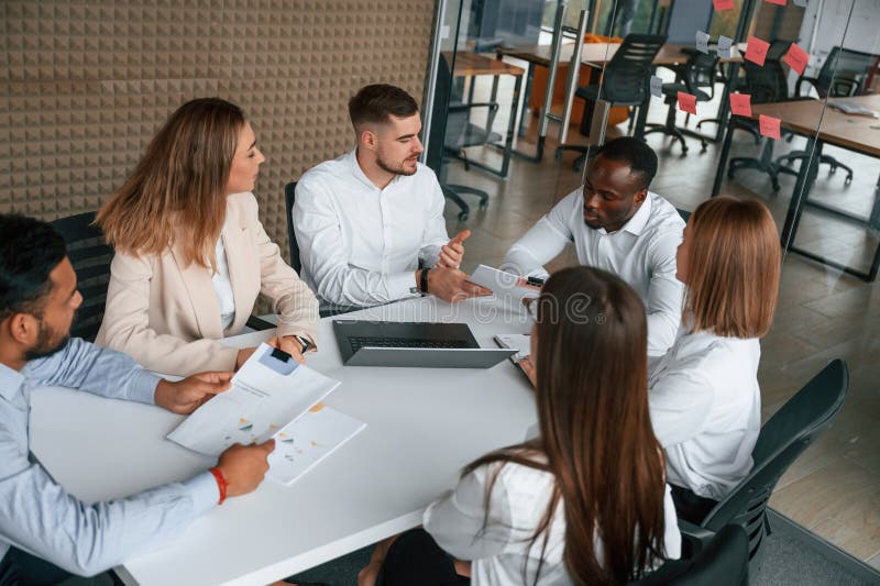 Brainstorming, Holding Documents, Thinking. Group of Office Workers are ...