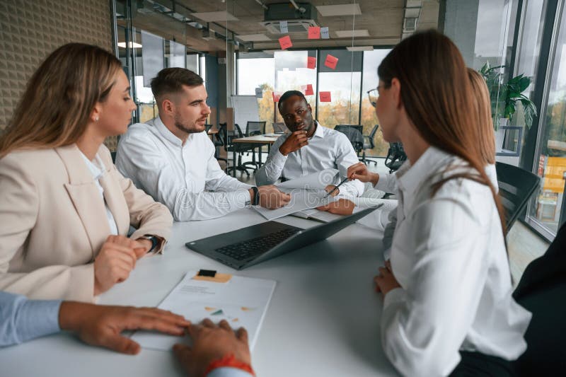 Brainstorming, Holding Documents, Thinking. Group of Office Workers are ...