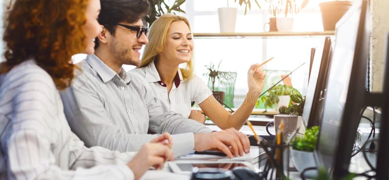 Young Project Team Working Together on Computers at Office Stock Photo ...