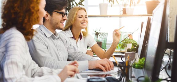 Young Project Team Working Together on Computers at Office Stock Photo ...