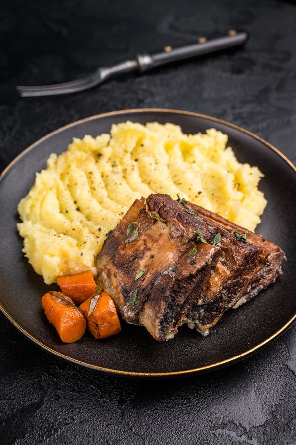 Braised Beef Short Ribs Resting on a Bed of Creamy Mashed Potatoes ...