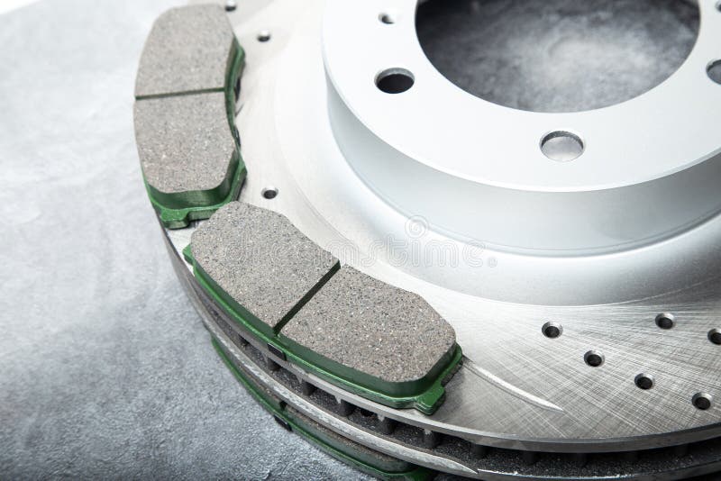 Brake Pads and Perforated Brake Discs on a Stone Gray Table Stock Image ...