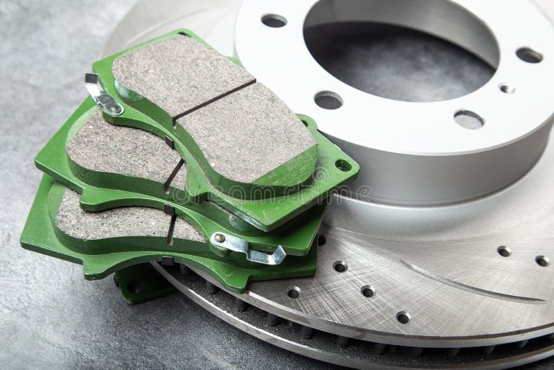 Brake Pads and Perforated Brake Discs on a Stone Gray Table Stock Image ...