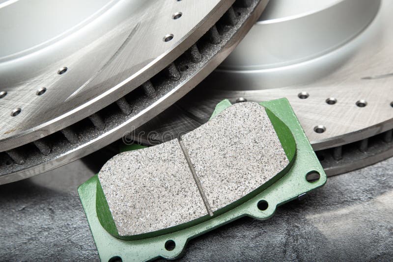 Brake Pads and Perforated Brake Discs on a Stone Gray Table Stock Image ...