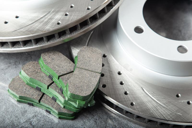 Brake Pads and Perforated Brake Discs on a Stone Gray Table Stock Image ...