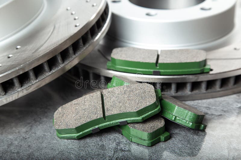 Brake Pads and Perforated Brake Discs on a Stone Gray Table Stock Image ...