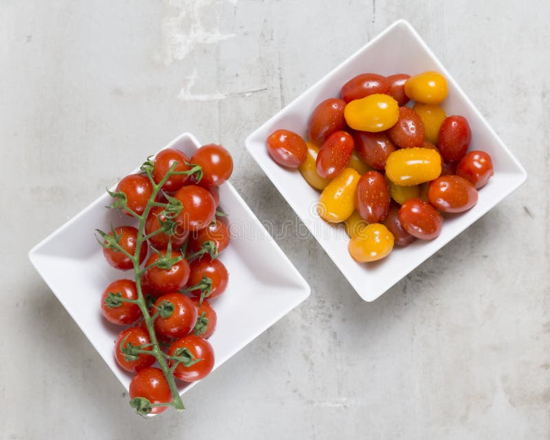 Branch of Red Small Tomatoes and Colored Tomatoes in White Square Bowl ...