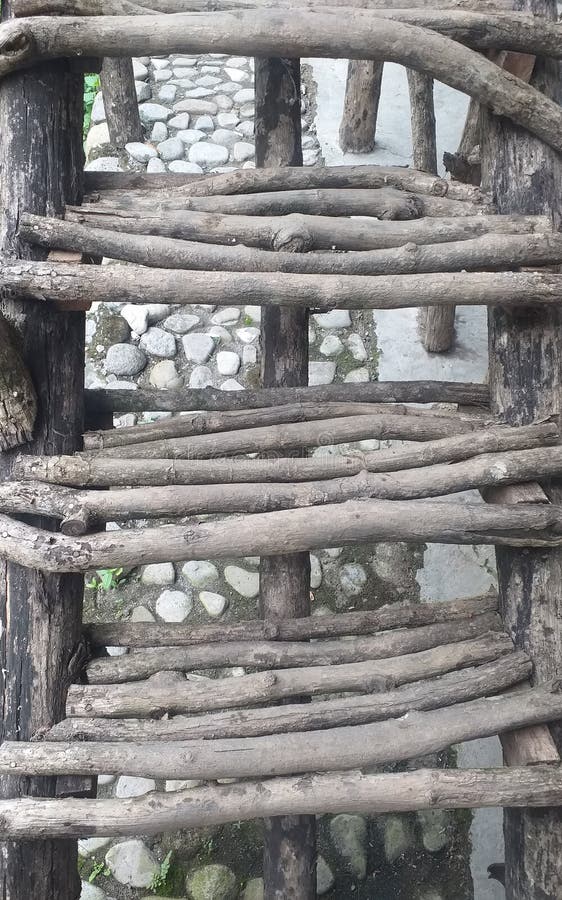 Branches Arranged Like a Ladder with Stone Structure Behind Stock Photo ...