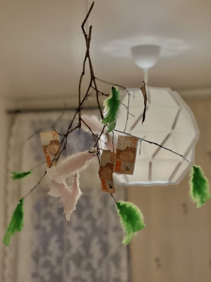 Branches of a Tree with Feathers and Banknotes Hanging from the Ceiling ...