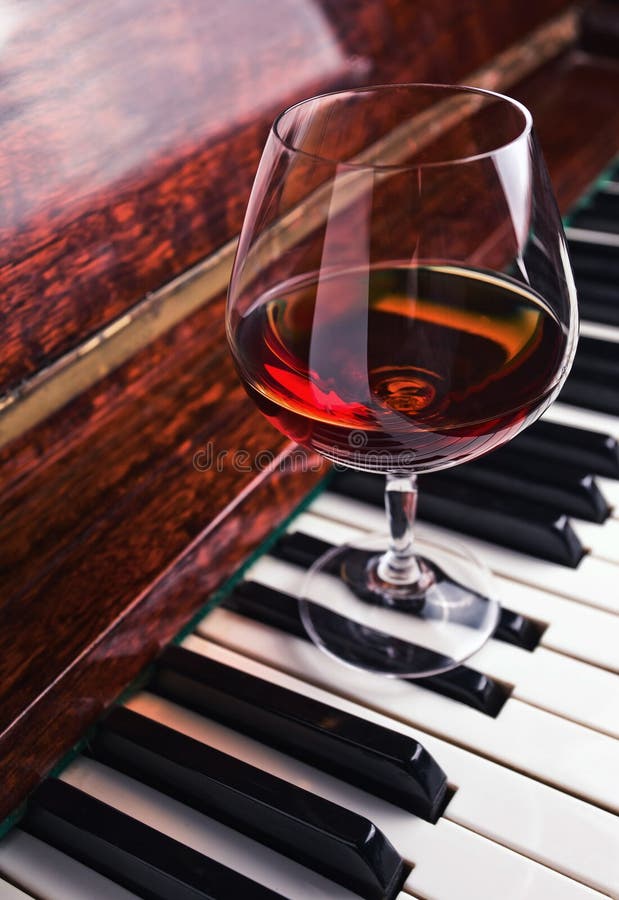 Brandy on old piano stock photo. Image of closeup, dark - 69931196