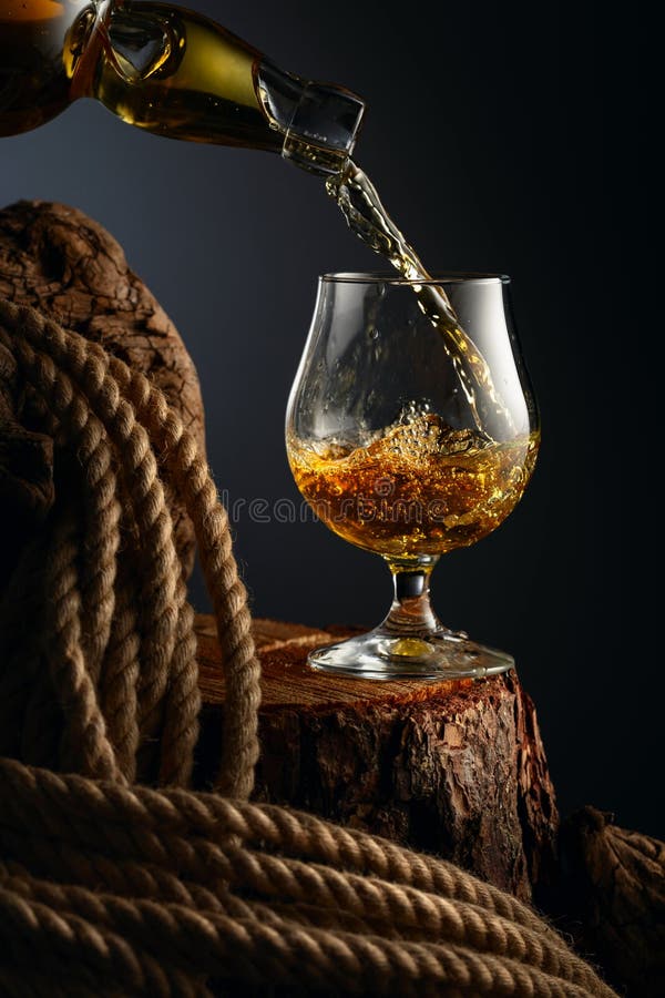 Brandy is Poured from a Bottle into a Glass Stock Photo - Image of ...