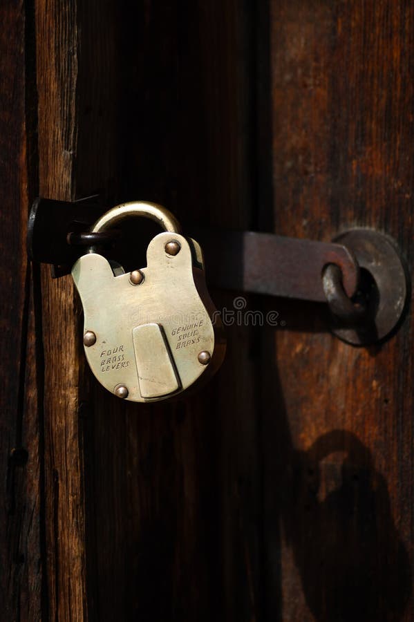 Brass Lock on Wooden Door stock photo. Image of brass - 364454550