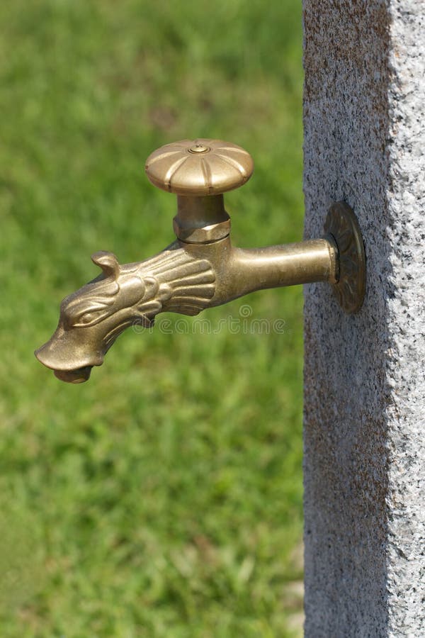 Brass tap on stone pillar stock photo. Image of drinking - 26019510