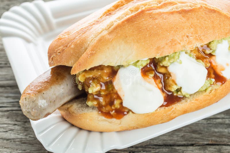 Bratwurst in a Roll with Guacamole Stock Image - Image of plate, sour ...