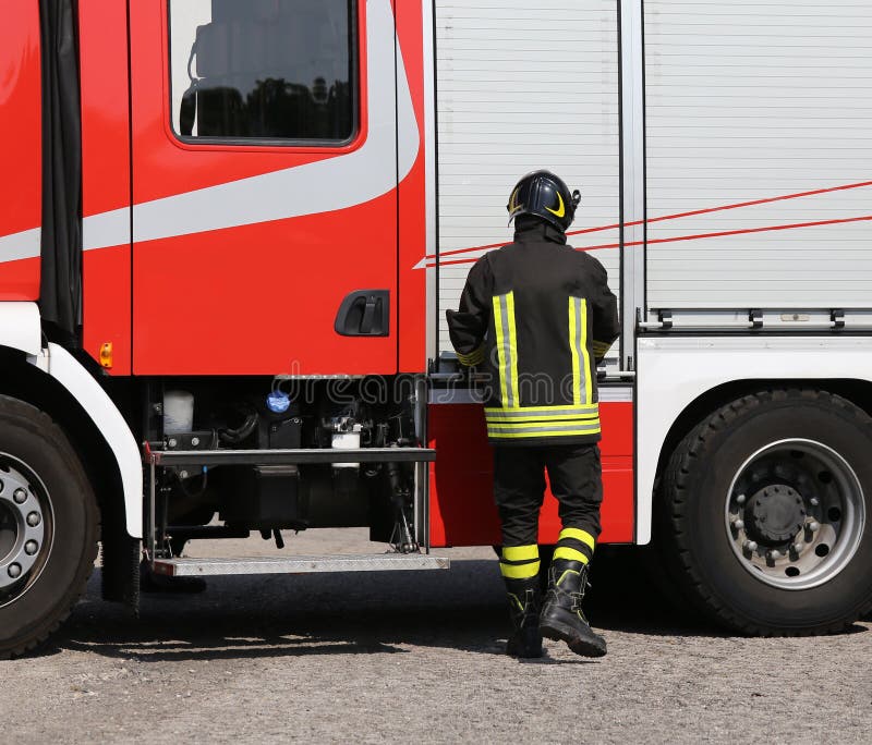 Brave Firefighter with Fire Engine Truck on the Road Stock Image ...