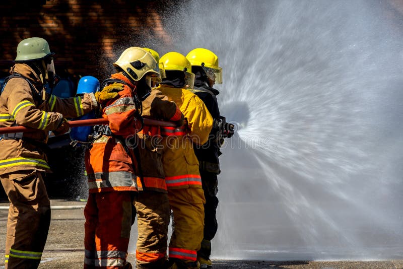 Brave Firefighter Using Extinguisher and Water from Hose for Fire ...