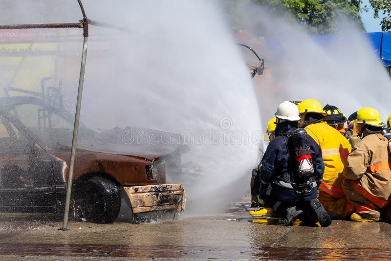 Brave Firefighter Using Extinguisher and Water from Hose for Fire ...