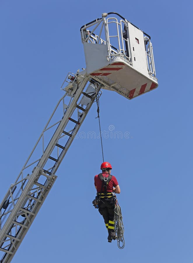 Two Firefighters with a Rope during the Rescue Operation Stock Image ...