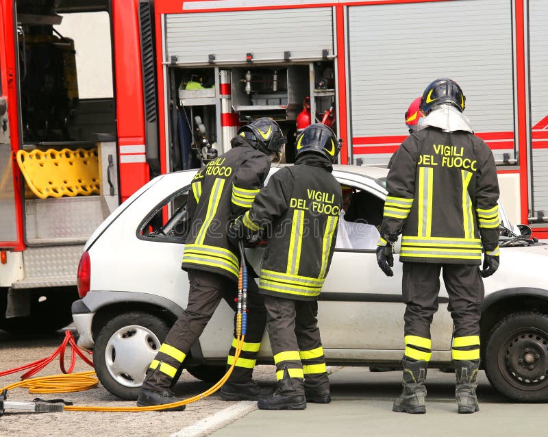 Brave Firefighters Relieve an Injured after a Road Accident Stock Image ...