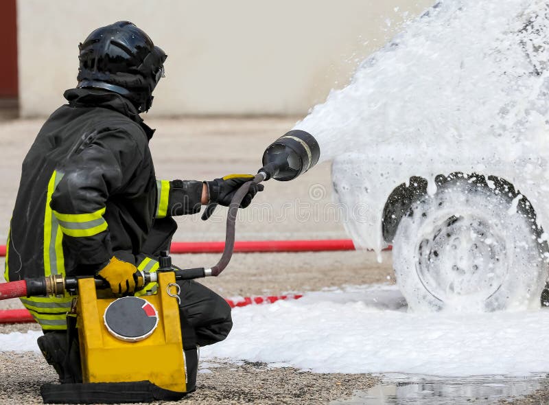 Brave Fireman Extinguishing the Fire of the Car with Foam after the ...