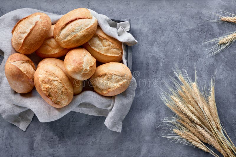 Bread Buns in Basket on Rustic Wood with Wheat Ears, Top View on Grey ...
