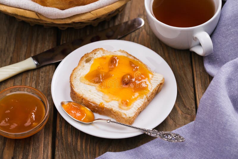 Bread with Butter, Apricot Jam and a Cup of Black Tea Stock Photo ...