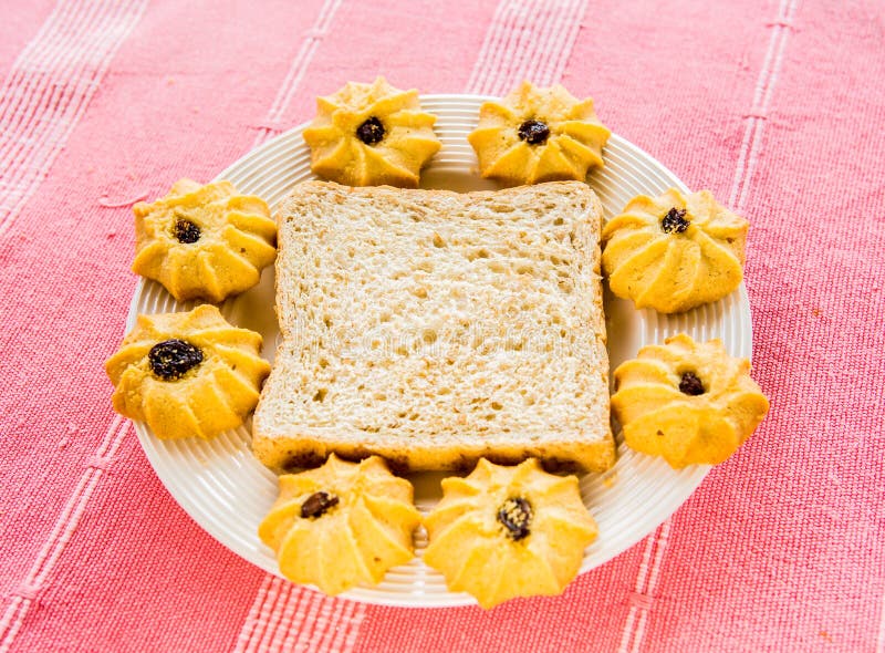 Bread and cookies on plate stock photo. Image of slice - 65825910