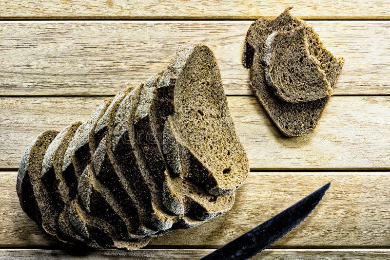 Bread Cut into Pieces and a Knife on the Table. Stock Photo - Image of ...