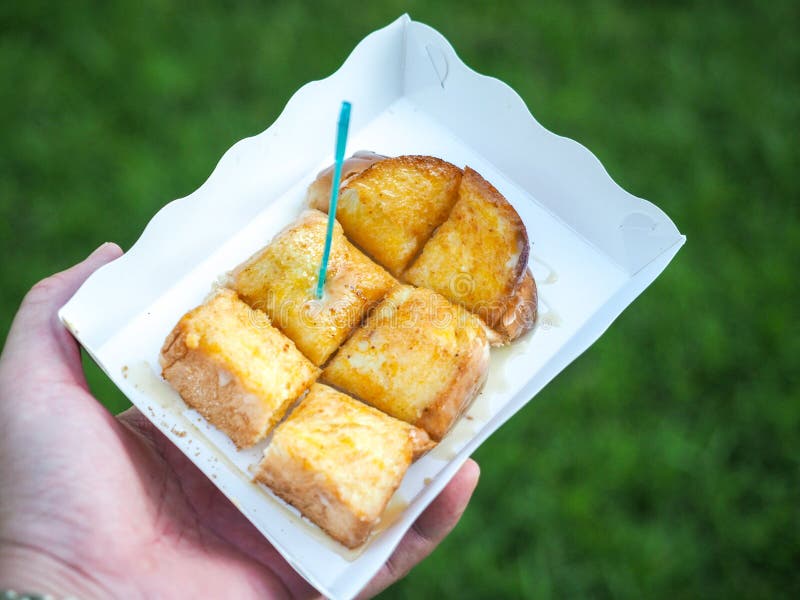 Bread Doused in Milk, Paper Plates Resting on Green Grass. Stock Photo ...
