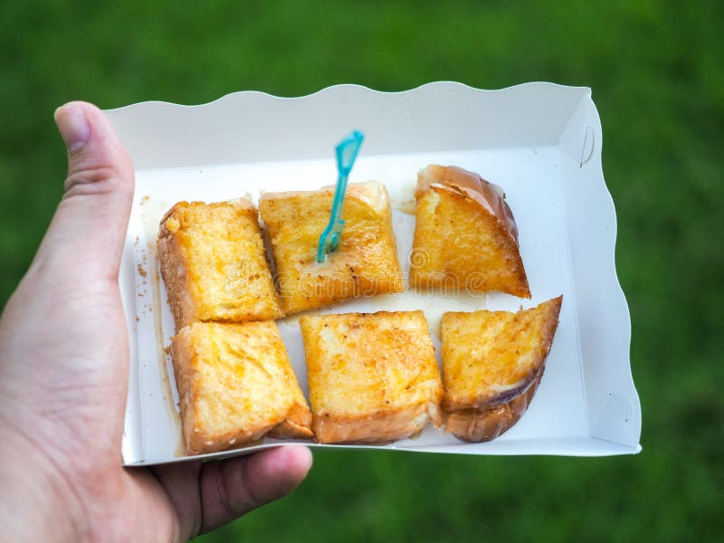 Bread Doused in Milk, Paper Plates Resting on Green Grass. Stock Photo ...