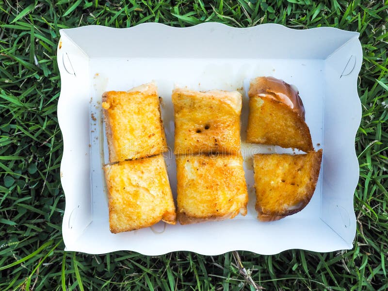 Bread Doused in Milk, Paper Plates Resting on Green Grass. Stock Image ...