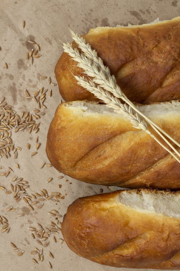 Bread Loaves on Craft Paper with Wheat Ears and Grain, Close-up Stock ...