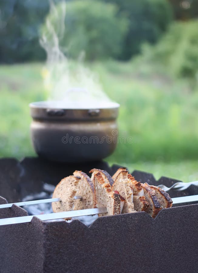 Bread and Meat on Skewer. Old Pan with Herbal Tea on Brazier. Stock ...