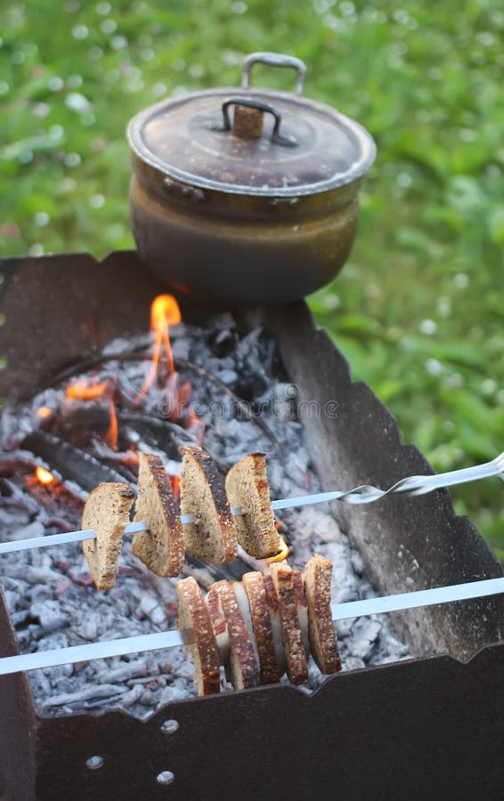 Bread and Meat on Skewer. Old Pan with Herbal Tea on Brazier. Stock ...