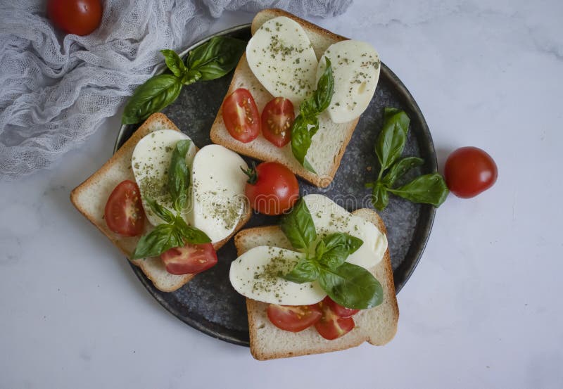 Bread with Mozzarella Cheese, Tomato on a Light Background Stock Photo ...