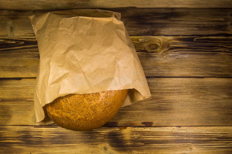 Bread Packed in Paper on Wooden Table Stock Photo - Image of bread ...