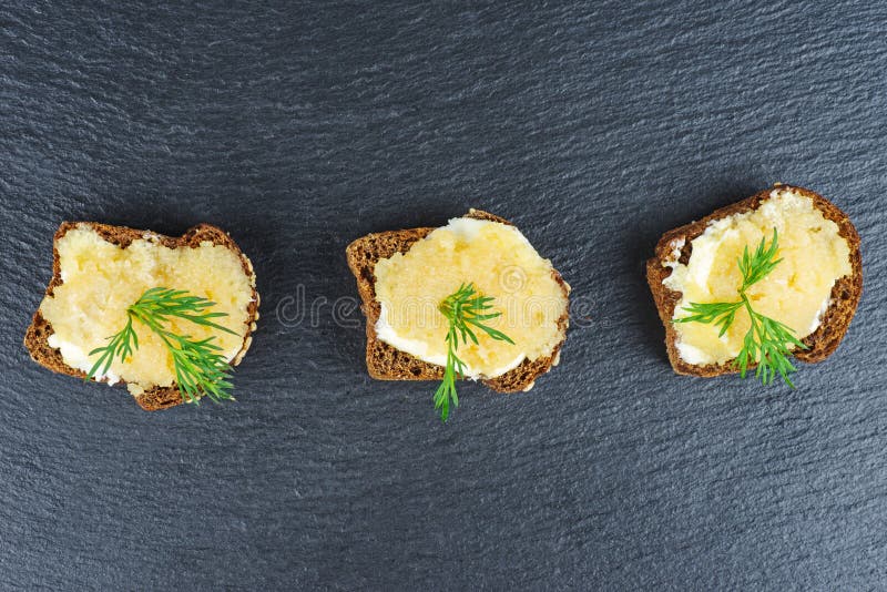 Bread Pieces with Delicious Cod Caviar Over Black Stone Slate Stock ...