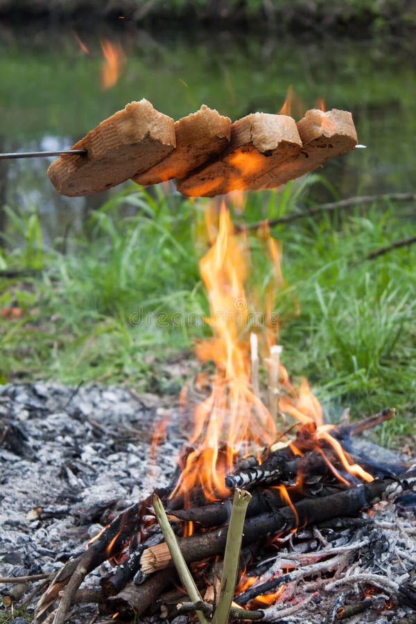 Bread roasting on the fire stock image. Image of bonfire - 106711239