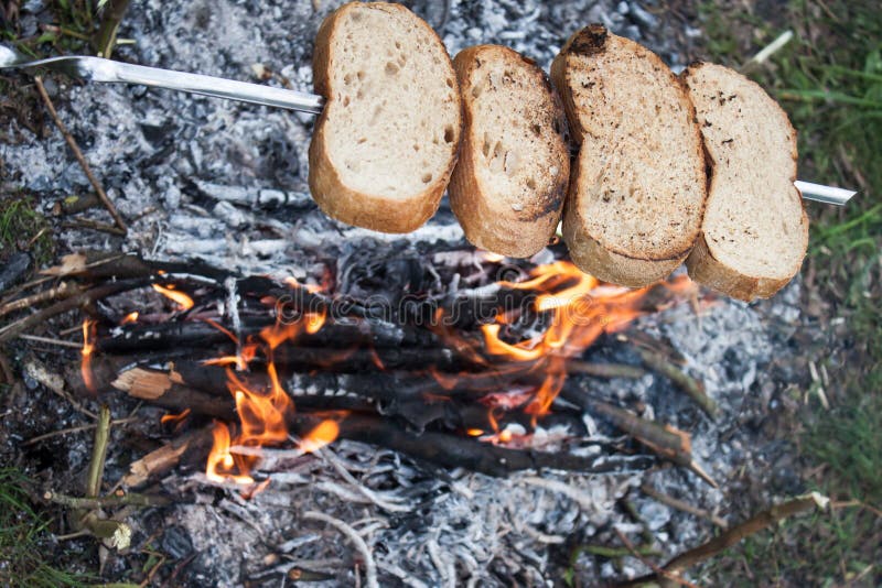 Bread roasting on the fire stock photo. Image of fire - 106711436