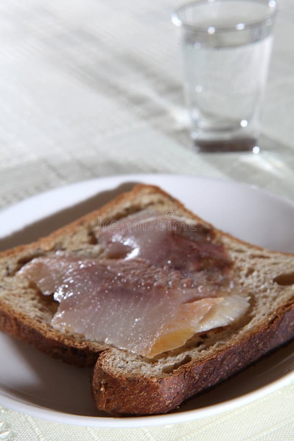 Bread, Salted Fish and Alcohol on a White Tablecloth Stock Image ...