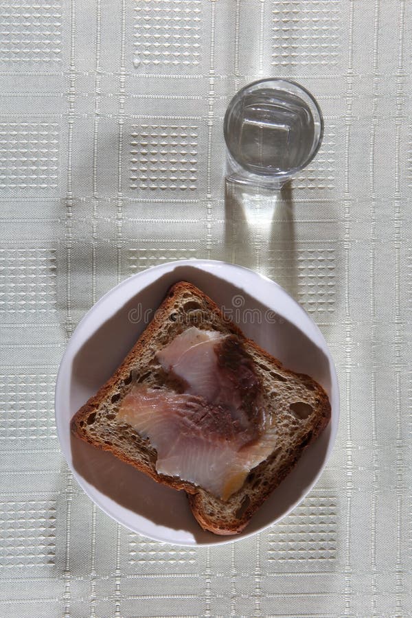 Bread, Salted Fish and Alcohol on a White Tablecloth Stock Image ...