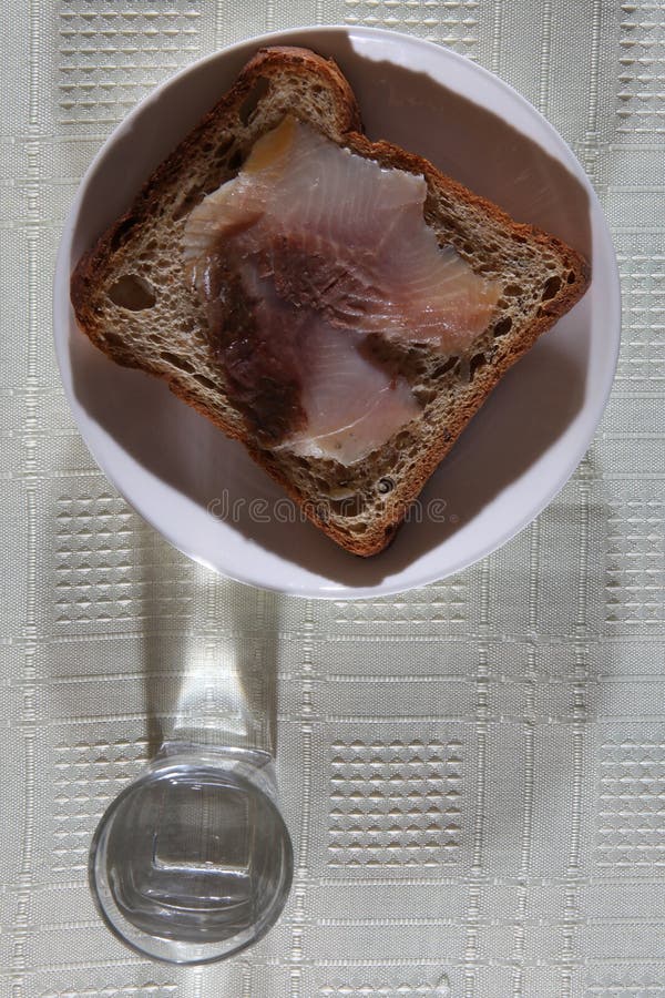 Bread, Salted Fish and Alcohol on a White Tablecloth Stock Photo ...