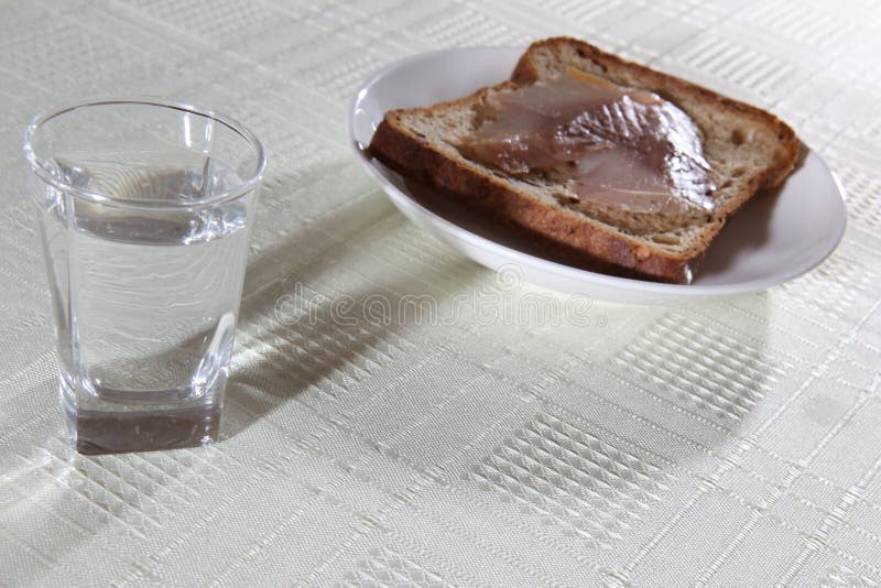 Bread, Salted Fish and Alcohol on a White Tablecloth Stock Image ...