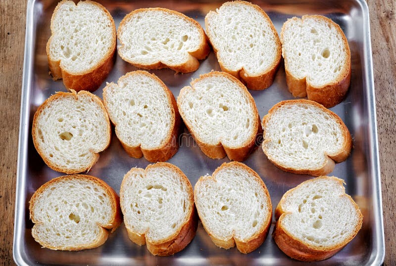 Bread slices on a pan stock photo. Image of baguette - 57365822