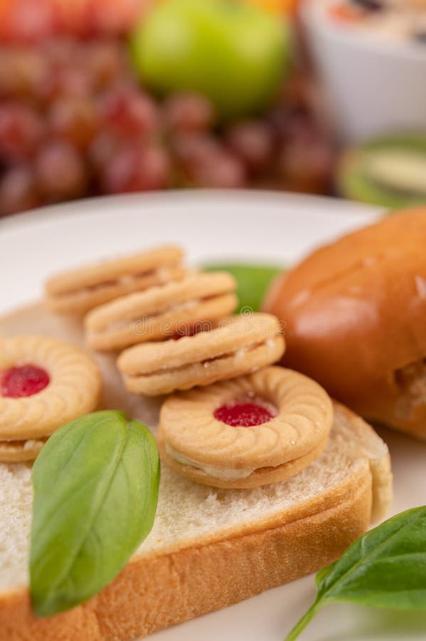 Bread Slices, Stuffed Buns, and Burgers on a White Plate Stock Photo ...