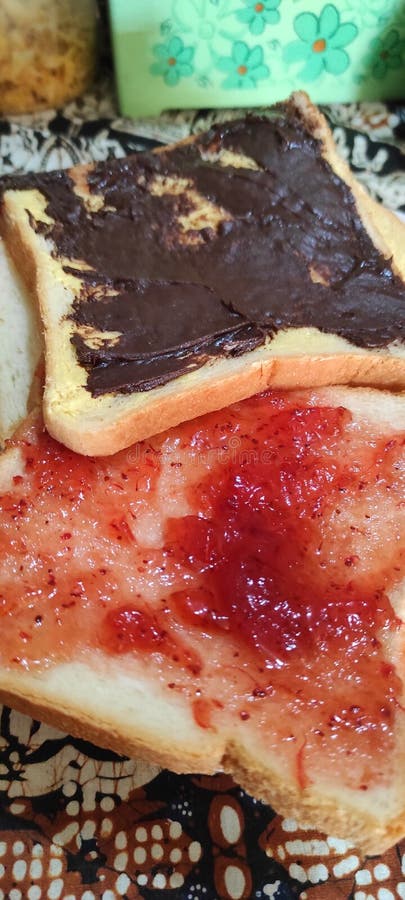 Bread Smeared with Chocolate Jam and Strawberry Jam on a Plate Stock ...