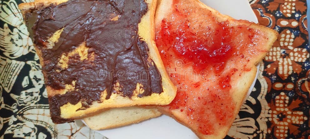 Bread Smeared with Chocolate Jam and Strawberry Jam on a Plate Stock ...