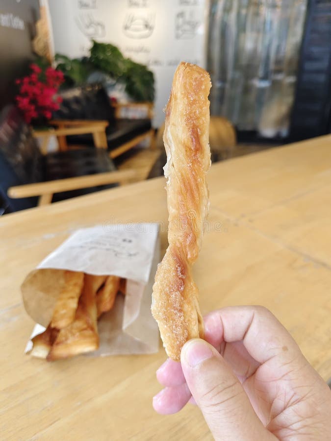 A bread stick in hand. stock photo. Image of finger - 319669492